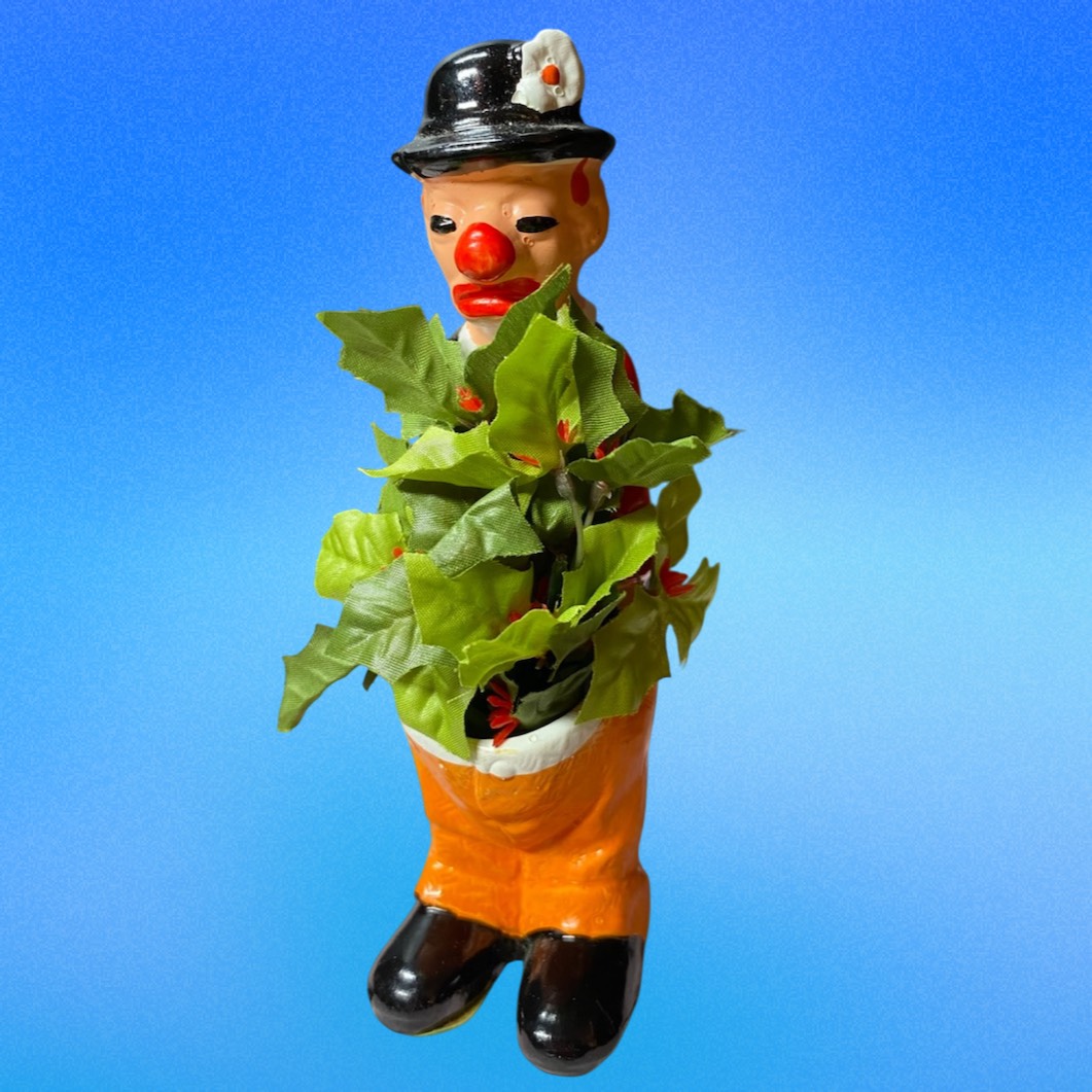 Sad Clown Planter With Plastic Greenery