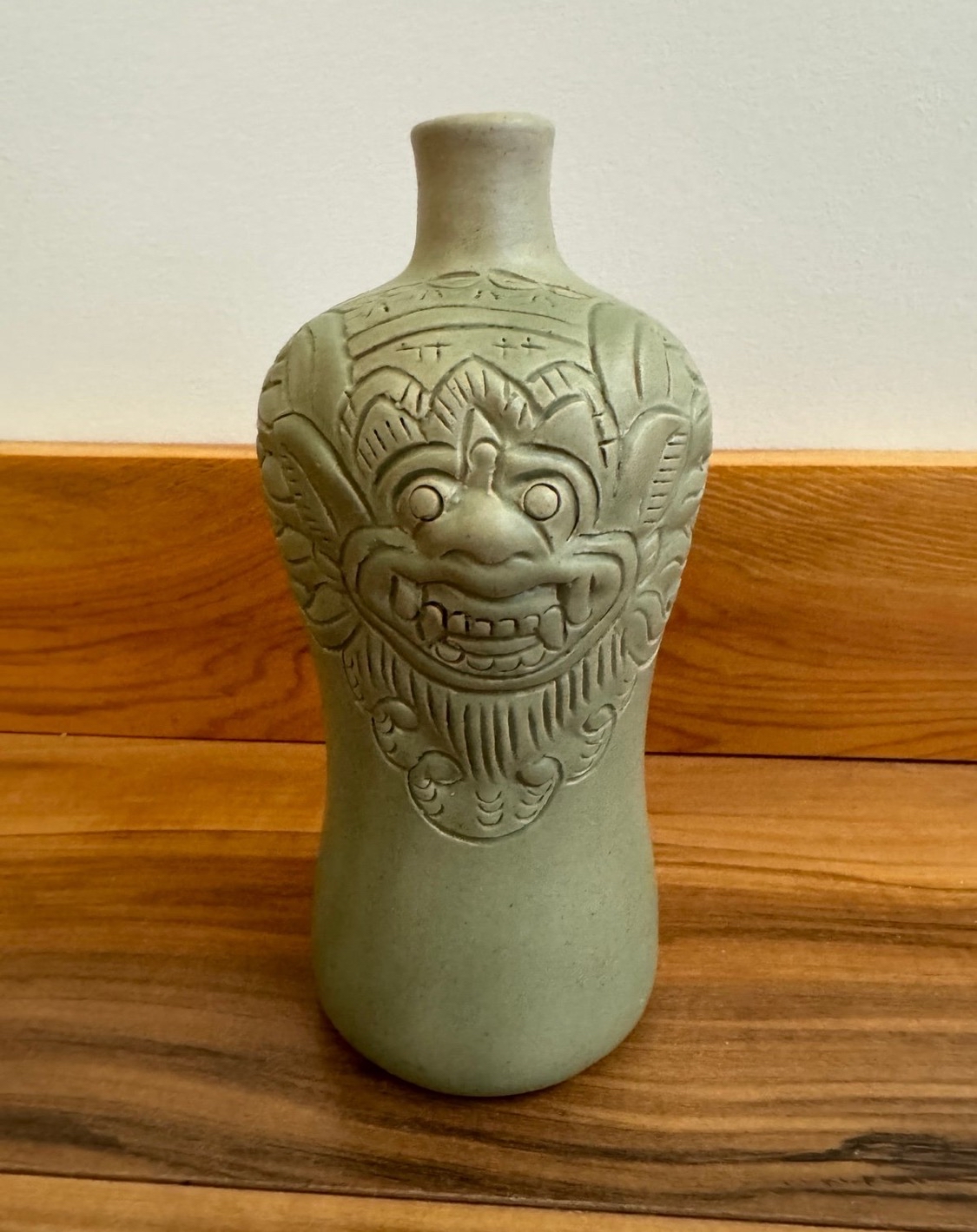 Vintage Arak Bali Indonesian hand pottery green bottle with incised Lion