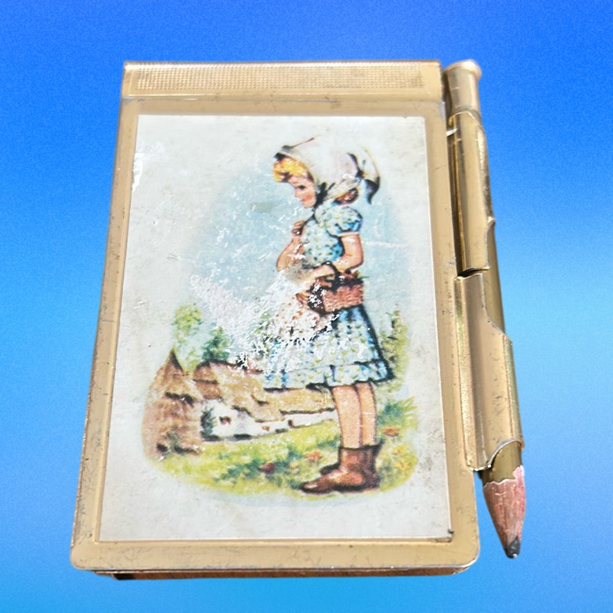 Tiny notepad with pencil. The middle case opens when you slide the pencil out there are a few ...