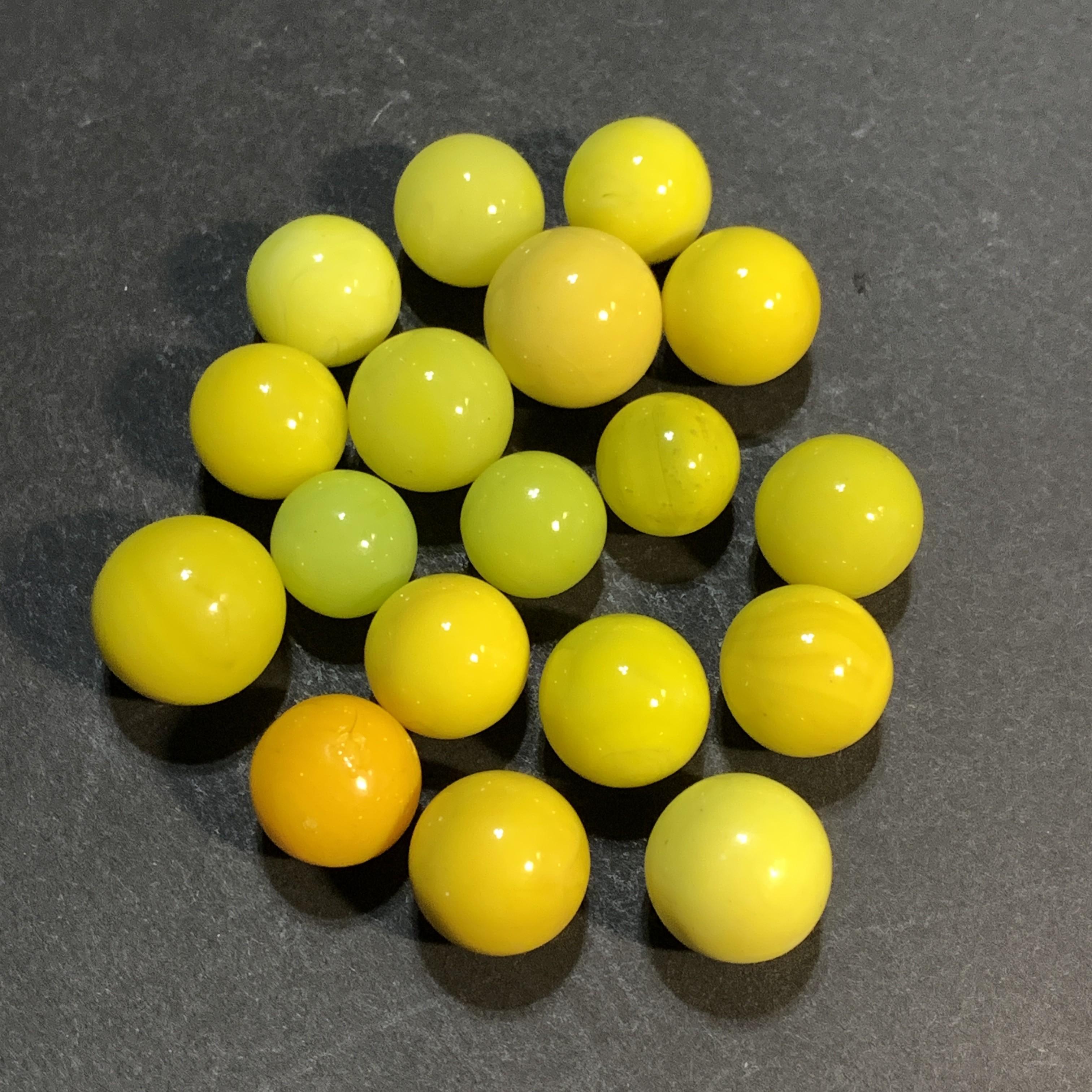 18 Yellow Glass Marbles Glow