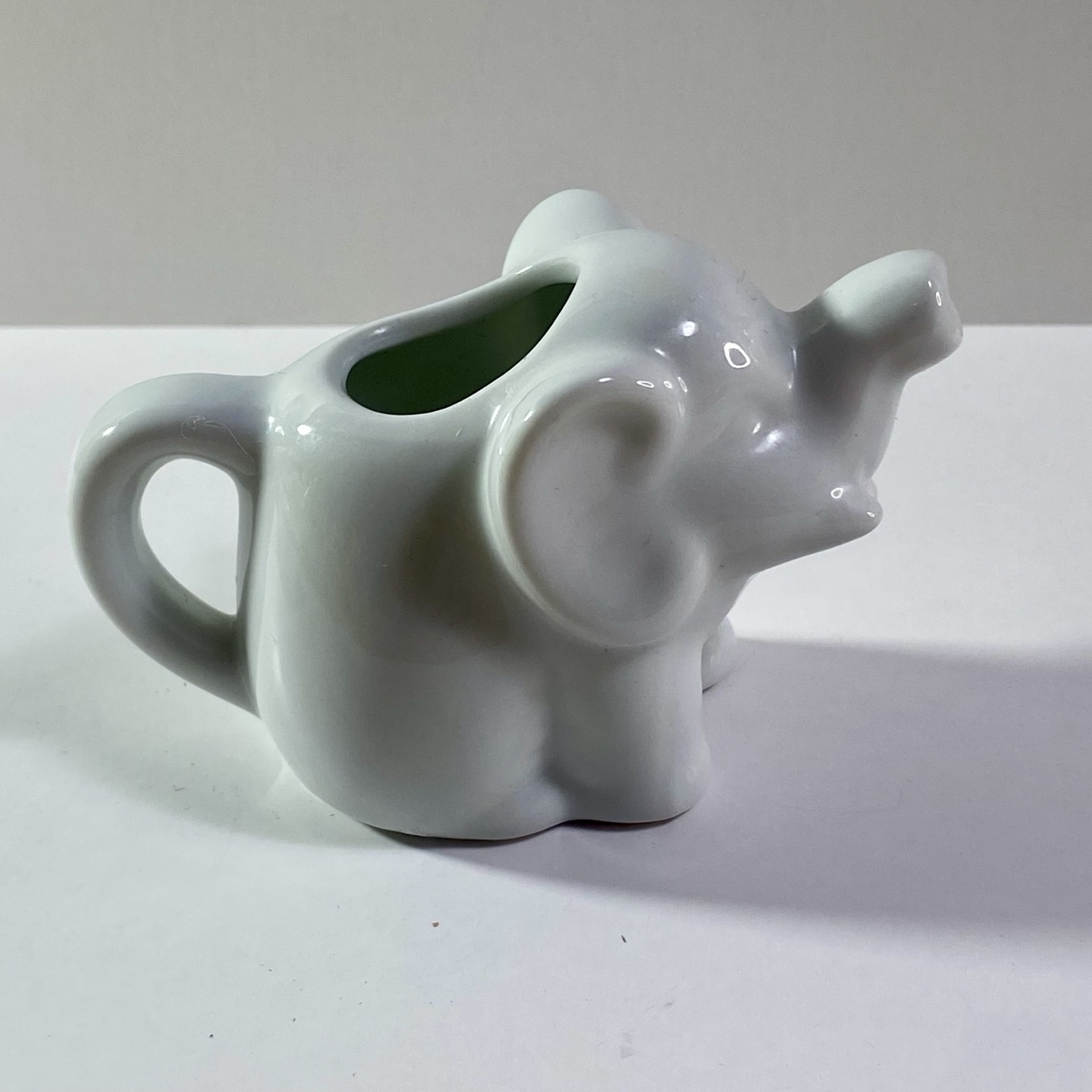022. Tiny White Ceramic Elephant Pitcher