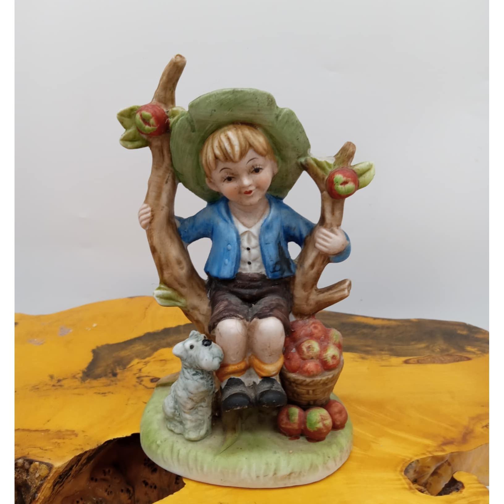 Boy in tree with apples figurine