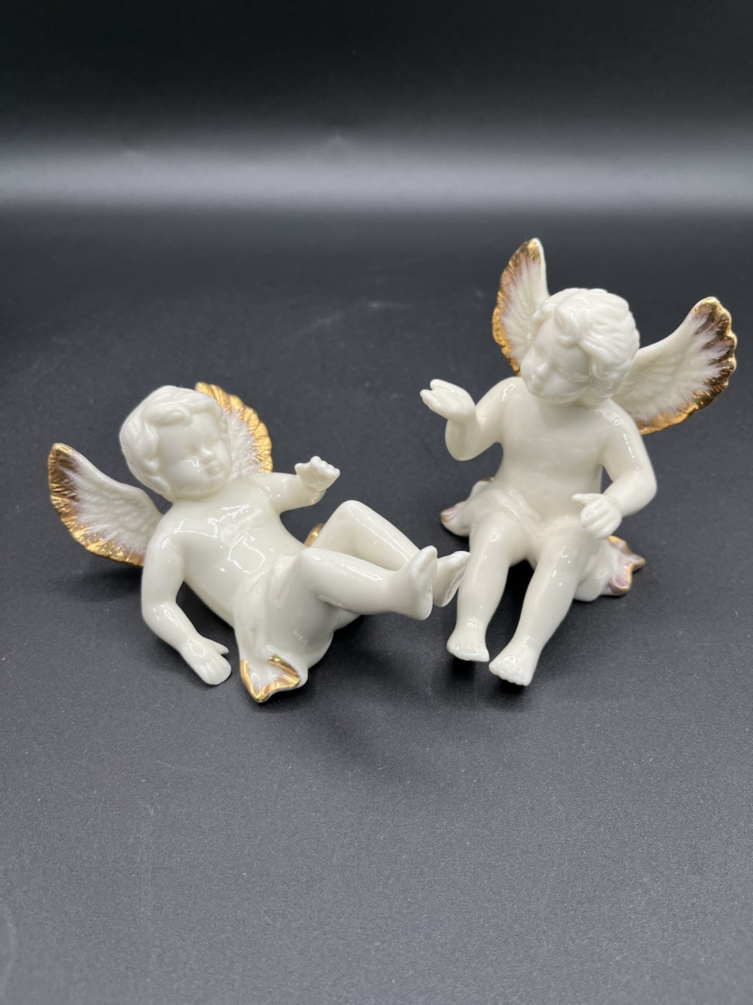 Pair Of Tumbling Porcelain Winged Cupid Angels One Seated One Leaning. 👼
